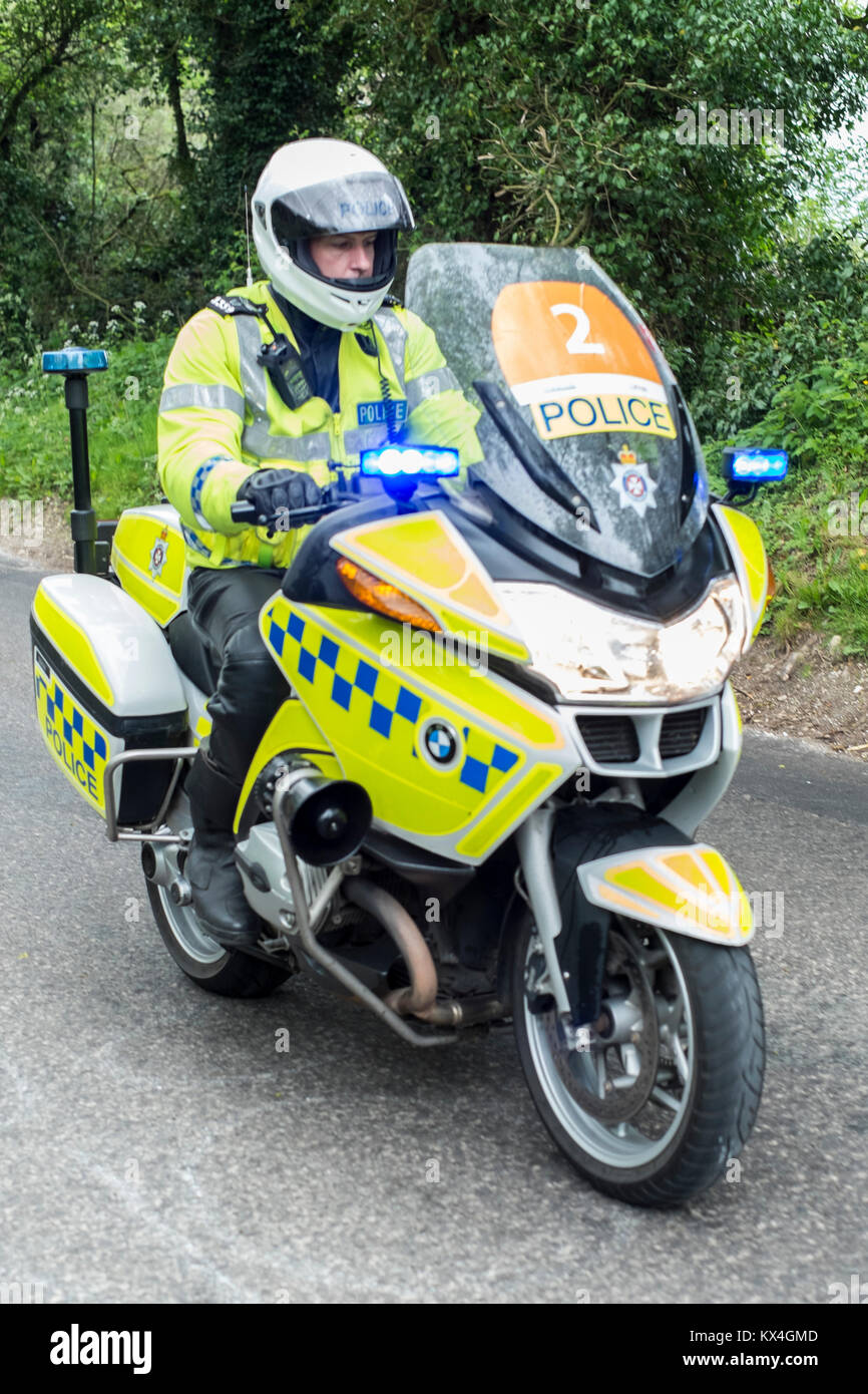 Police Motorcyclist on a country road with blue lights on Stock Photo ...