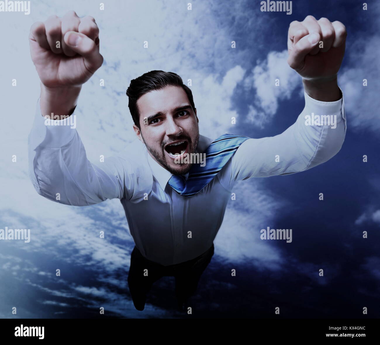 Happy businessman flying in the sky Stock Photo - Alamy