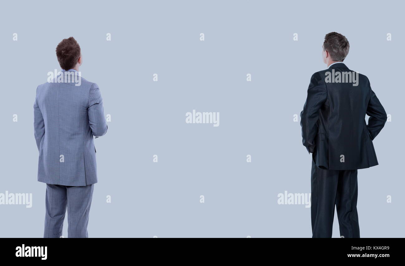 two business mans from the back - looking at something over a white ...