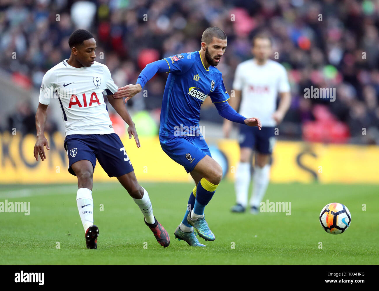 AFC Wimbledon's George Francomb (right) and Tottenham Hotspur's Kyle ...