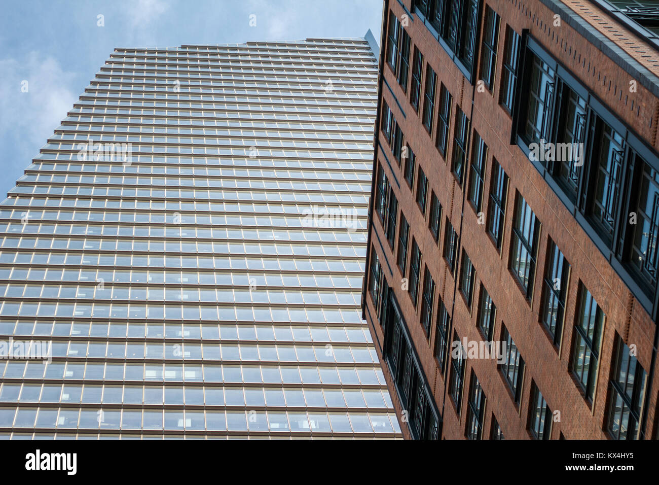 Bottom view of modern skyscraper and brick building Stock Photo - Alamy