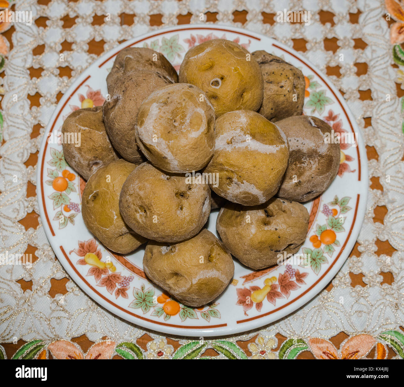 Canarian wrinkled potatoes on a white plate with drawing Stock Photo ...