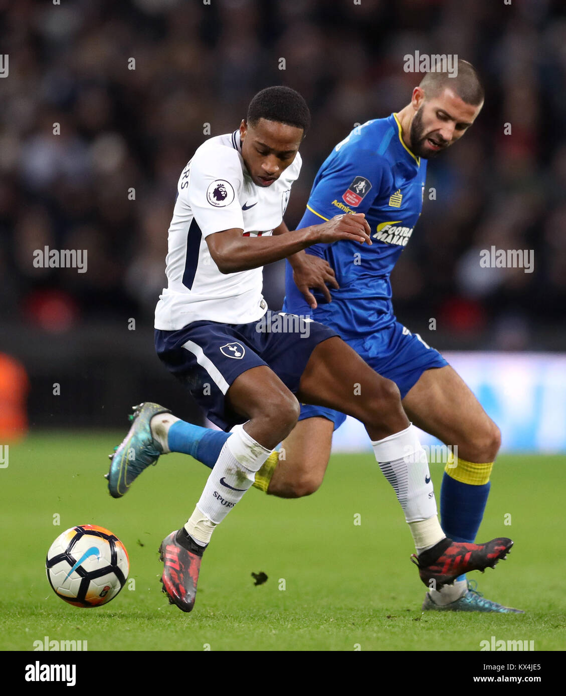 Tottenham Hotspur's Kyle Walker-Peters (left) and AFC Wimbledon's ...