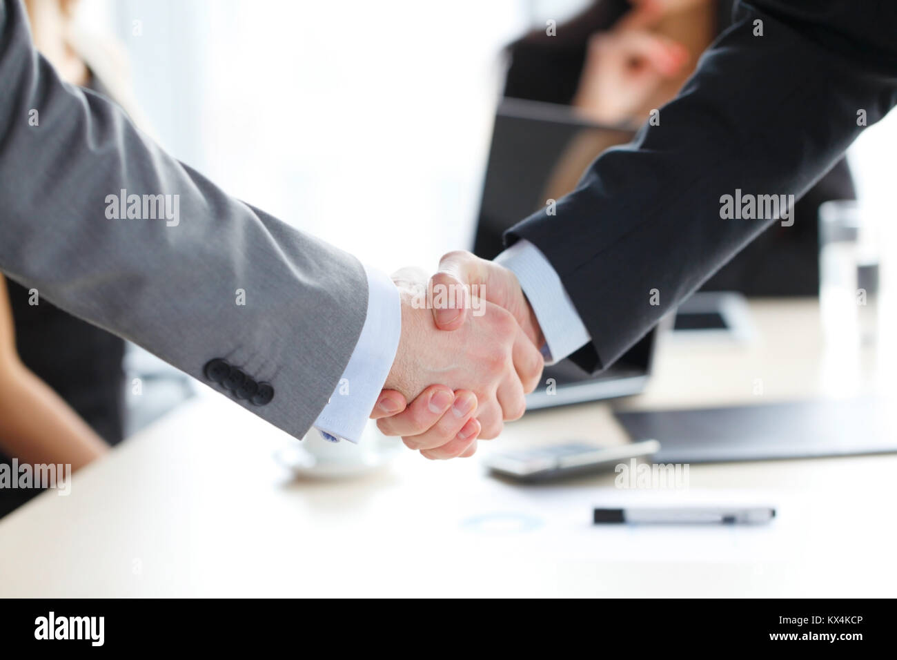 Business handshake of two executive persons in office Stock Photo - Alamy