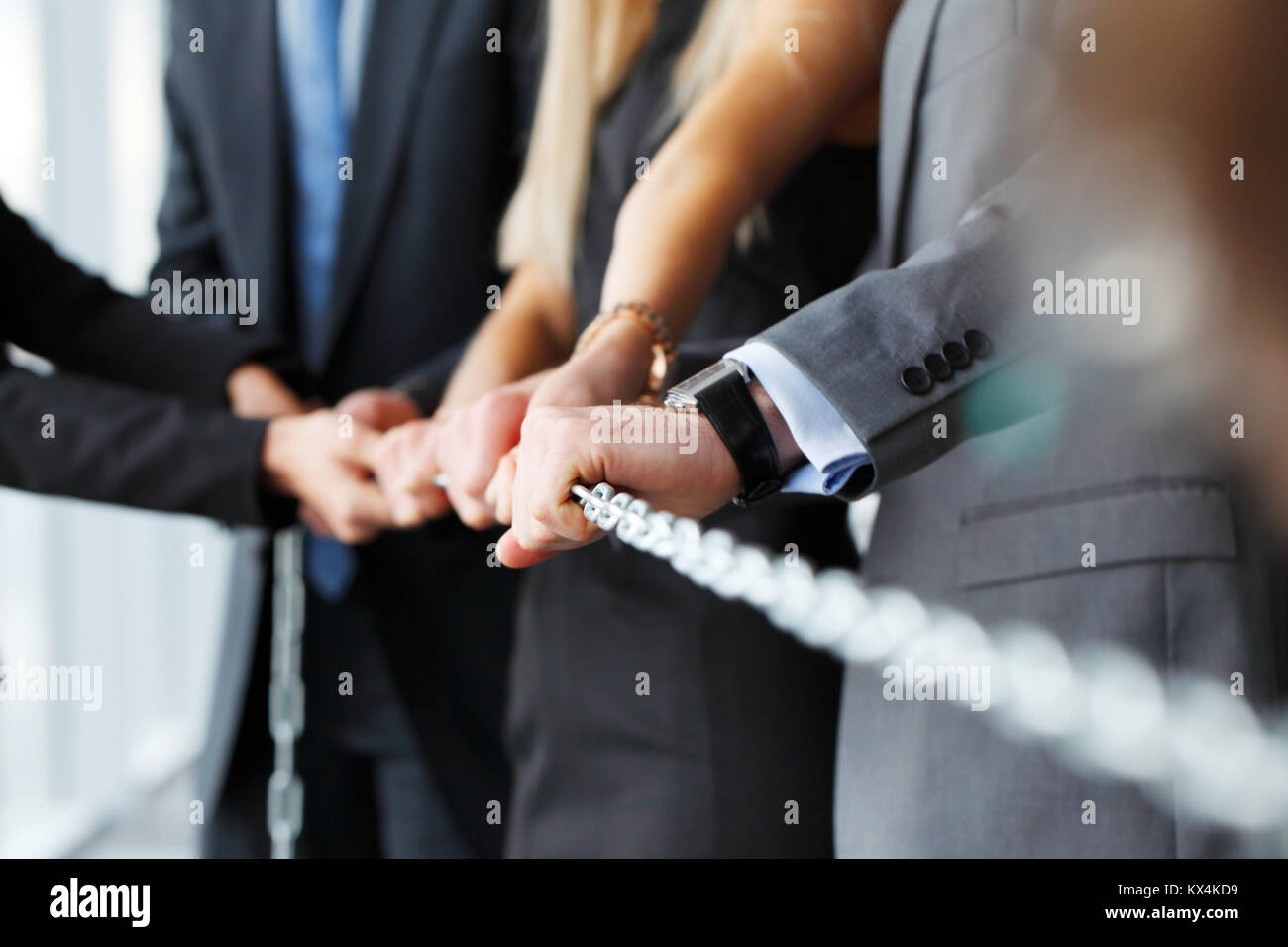 Businessmen pulling chain, teamwork togetherness concept Stock Photo ...