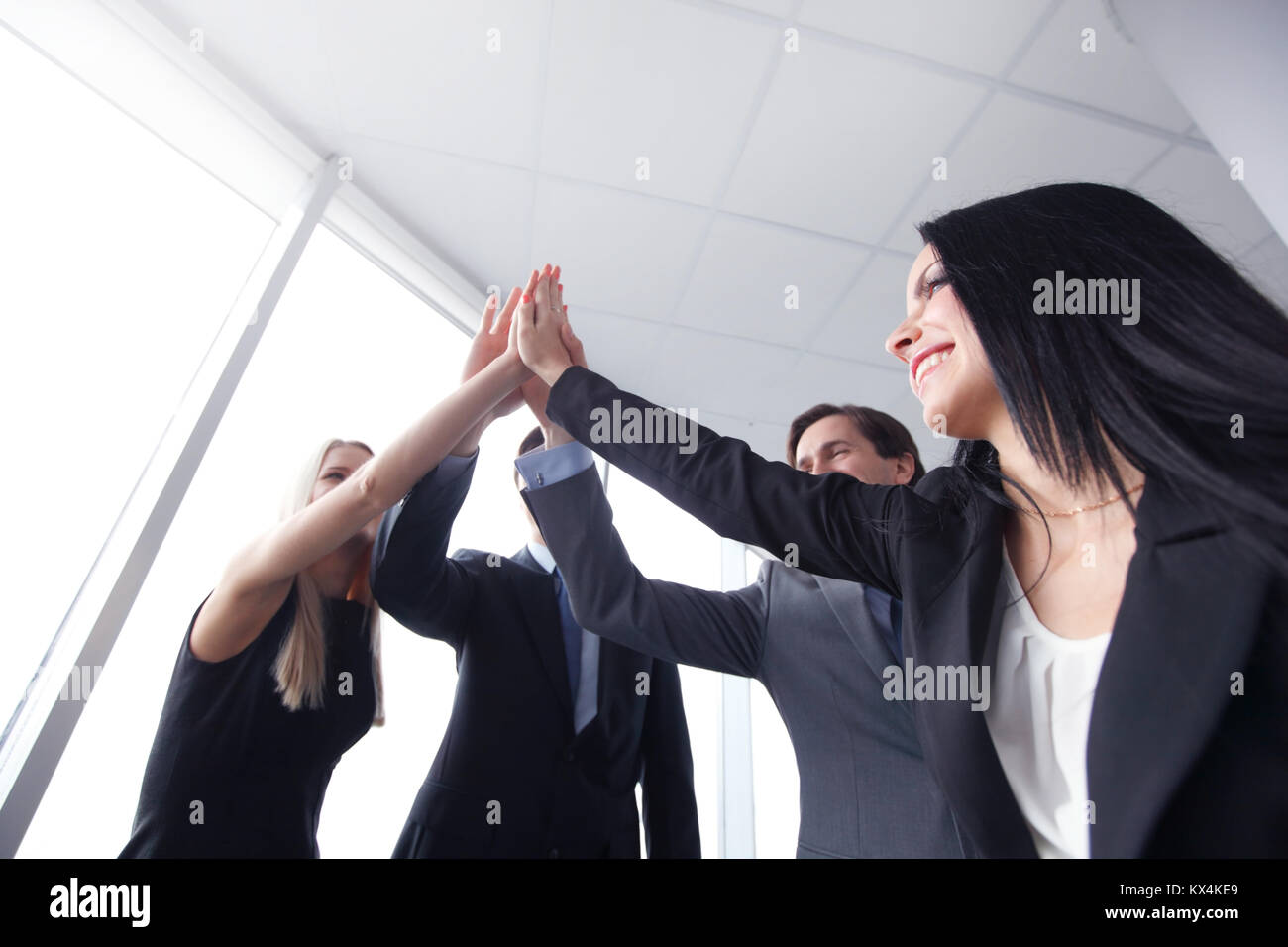 Happy business people hands giving high five Stock Photo - Alamy