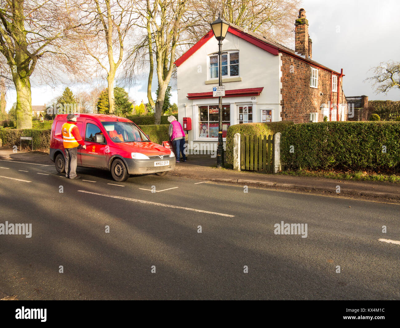 Postman collecting the mail in his van from the post office and village ...
