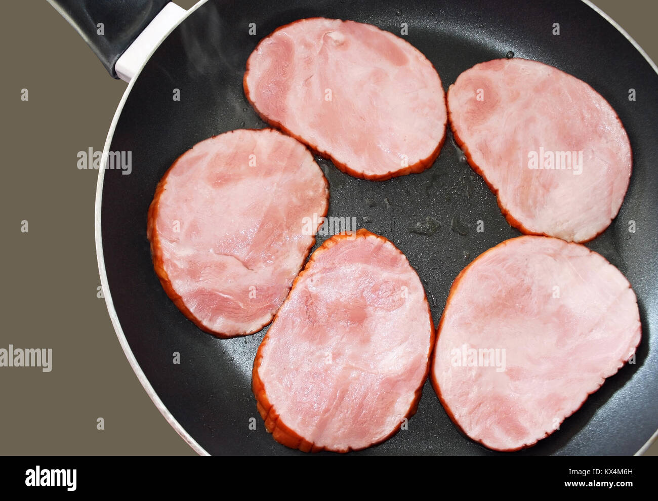 Lean slices of ham cooking in skillet Stock Photo - Alamy