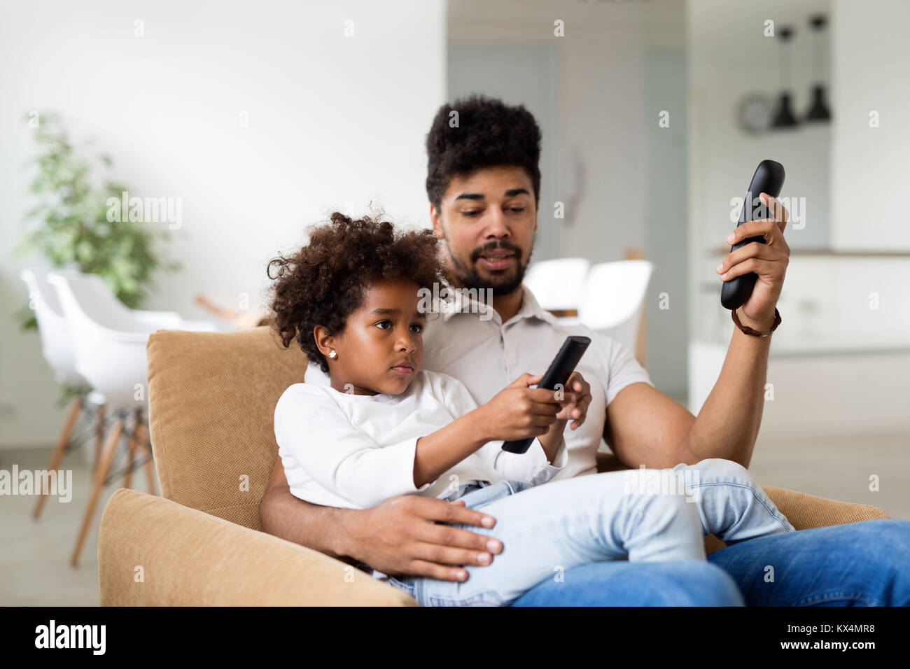 Father and young daughter watching tv hi-res stock photography and ...