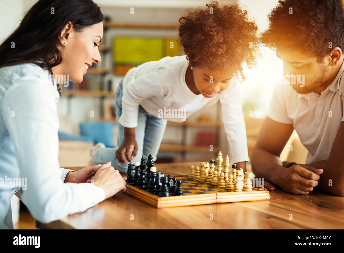 Happy family playing chess together Stock Photo - Alamy