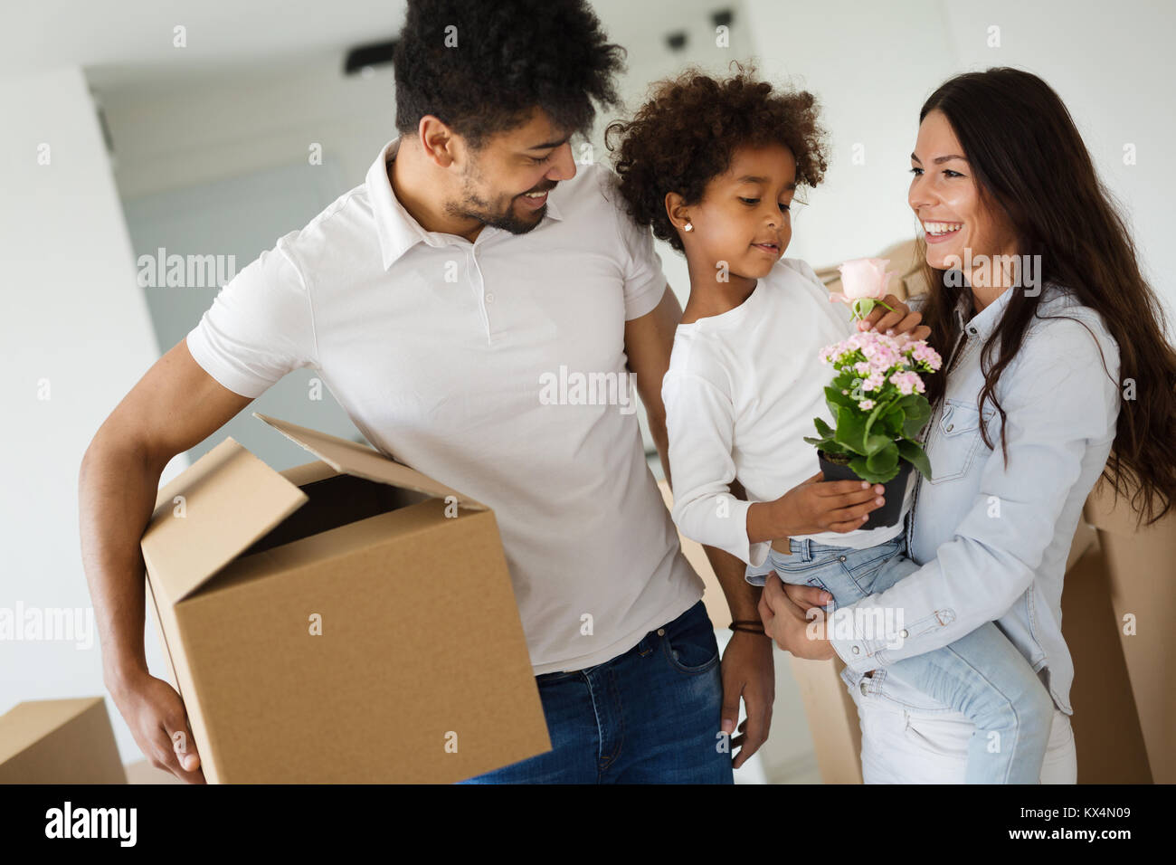 Happy family with cardboard boxes Stock Photo - Alamy