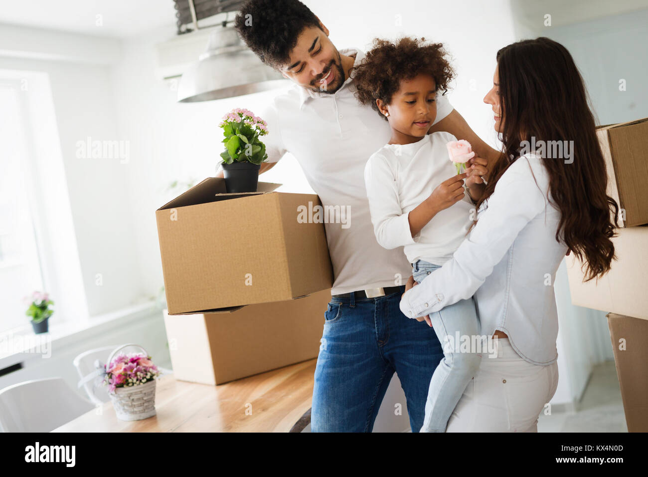 Happy family with cardboard boxes Stock Photo - Alamy