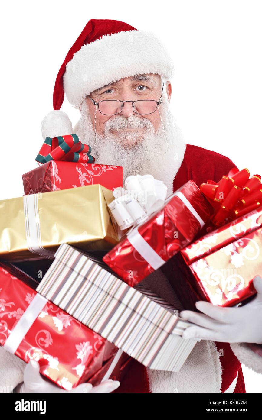 Santa Claus or Father Christmas holding a large pile of presents ...