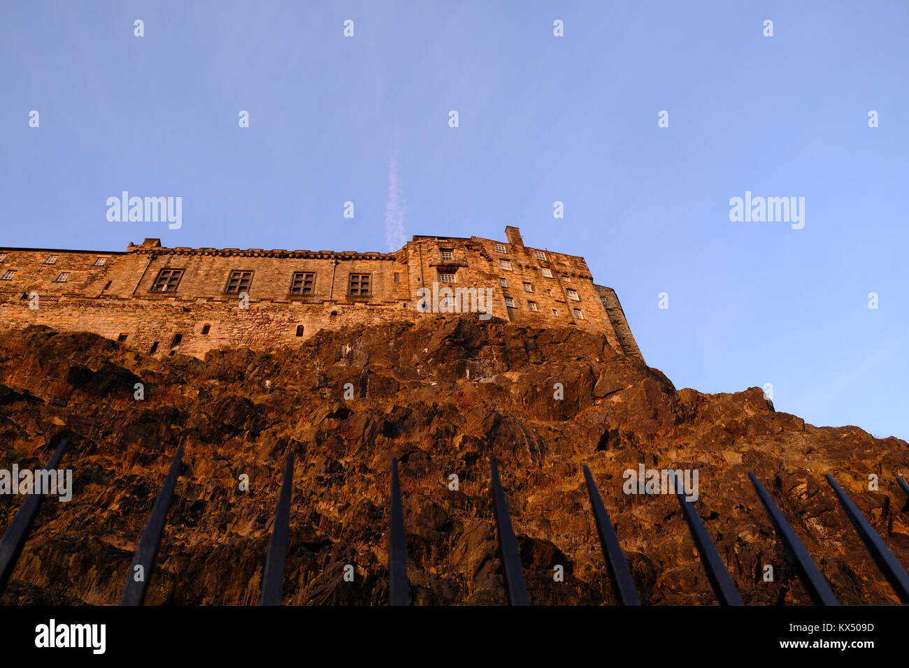 Sunset over Edinburgh Castle in Old Town area with blue clear skies ...