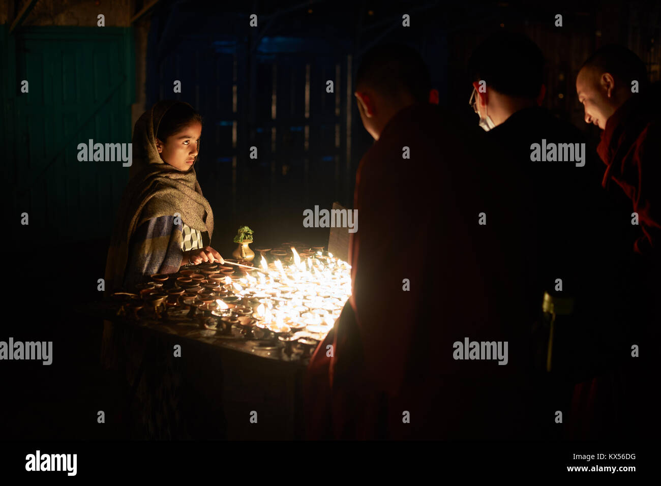 Nepali girl lighting buddhist candles, Boudhanath, Kathmandu, Nepal ...
