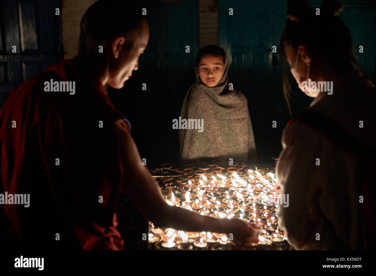 Nepali girl lighting buddhist candles, Boudhanath, Kathmandu, Nepal ...