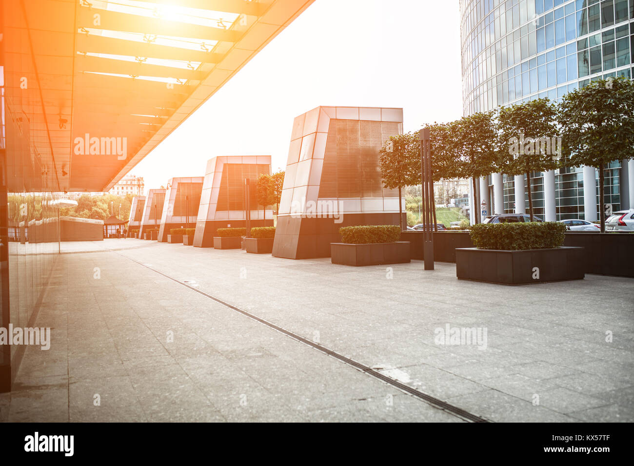 modern city street footpath with glass windows wall and sunlight with ...
