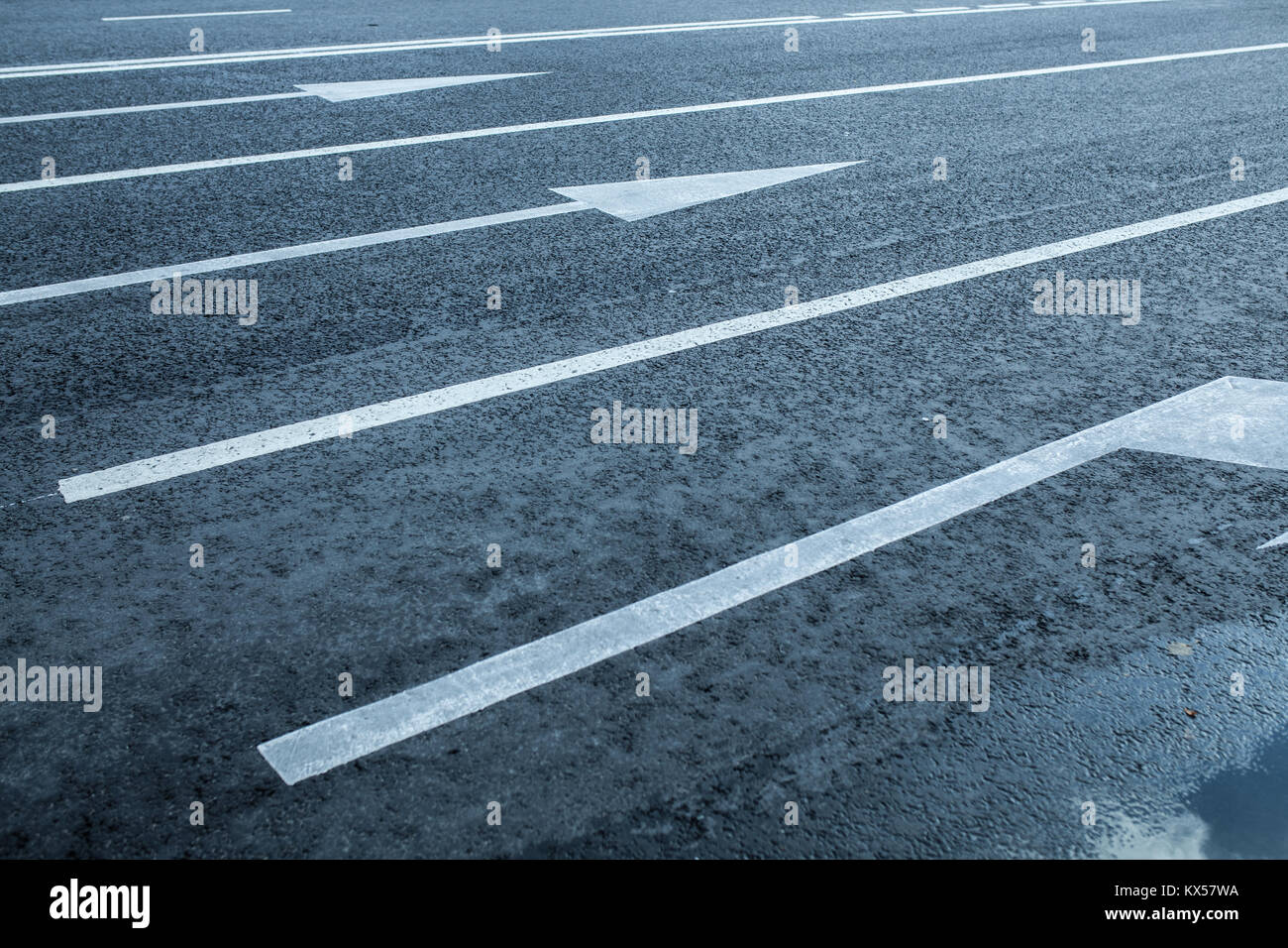 Road lanes with arrow markings at sunset for turn Stock Photo - Alamy