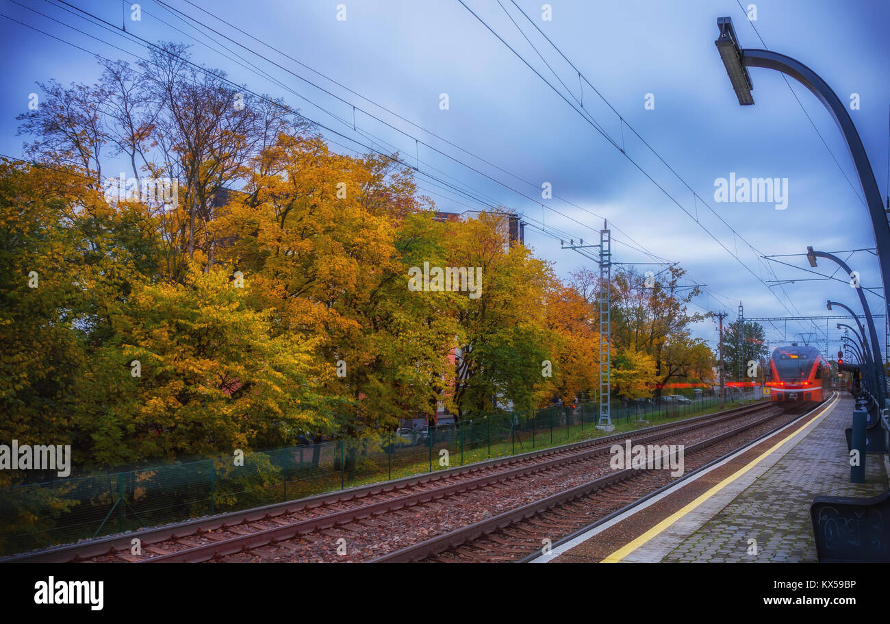 Railroad platform in autumn, with long exposure Stock Photo - Alamy