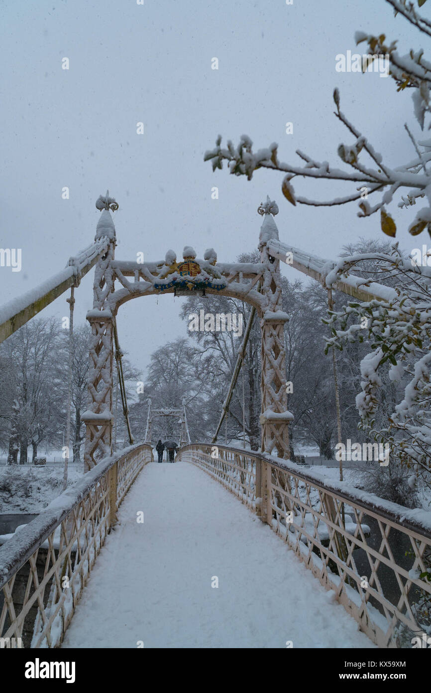 Braving the snow storm people crossing the Victoria Bridge Hereford UK ...
