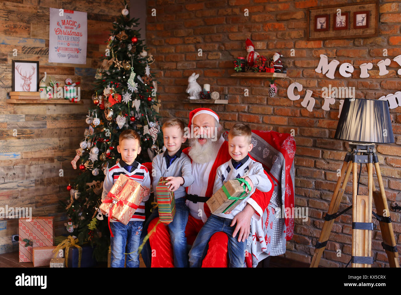 Native brothers boys sing Christmas carols to Santa Claus in roo Stock ...