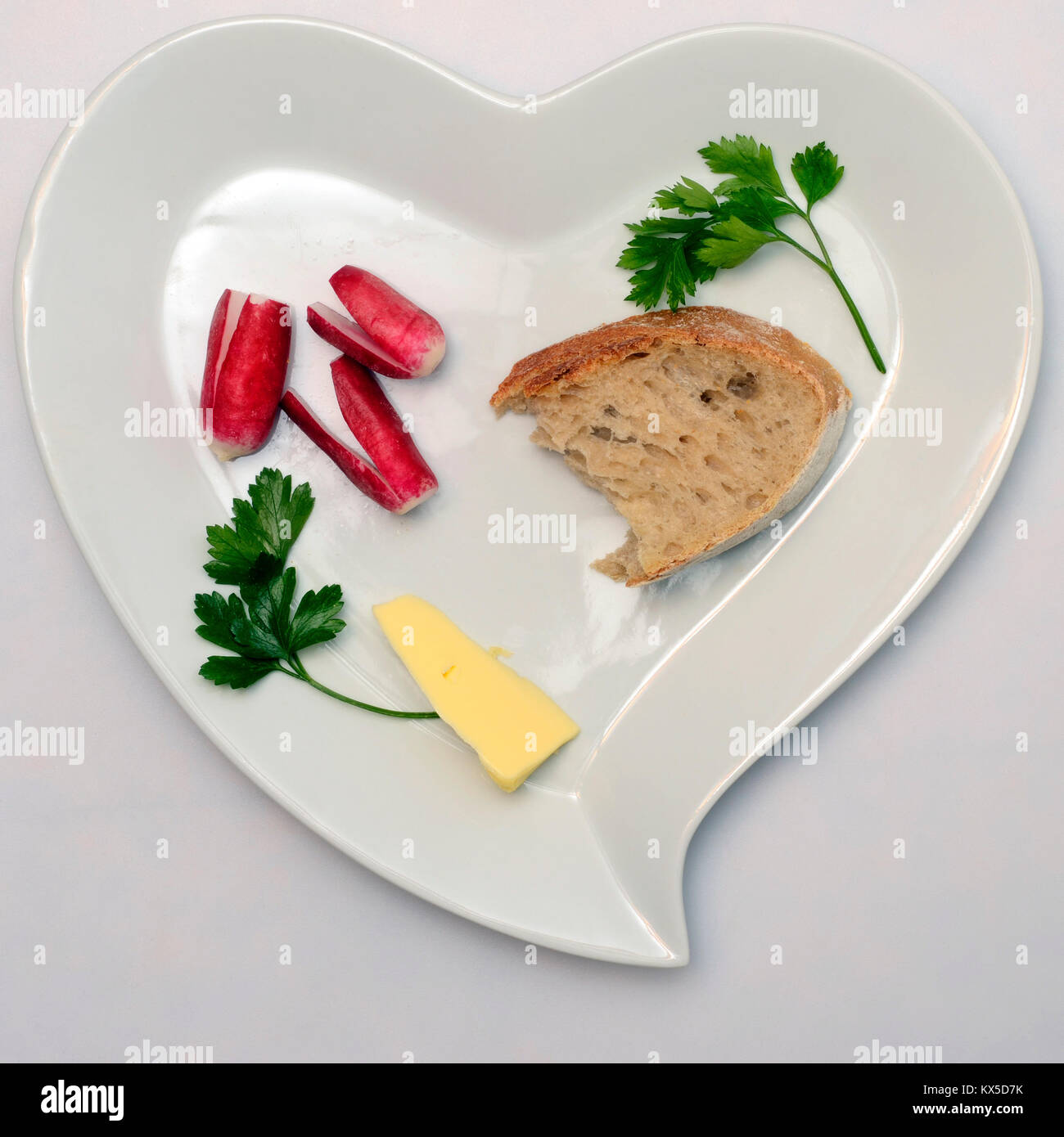 Heart shaped plate : radish, bread and butter, healthy food Stock Photo ...