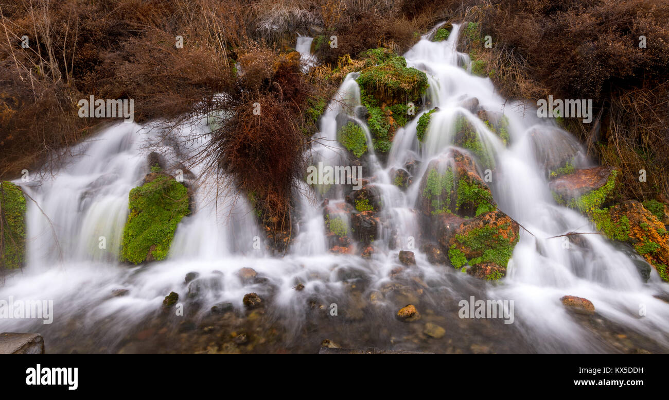 Natural waterfall spring flows down the side of a hill Stock Photo - Alamy