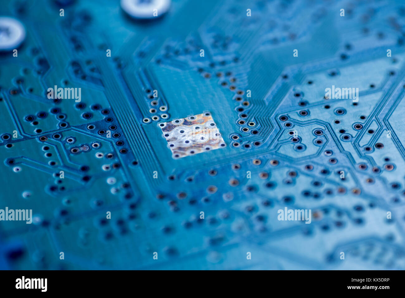 extreme close up of computer part with microcircuits in blue color with ...