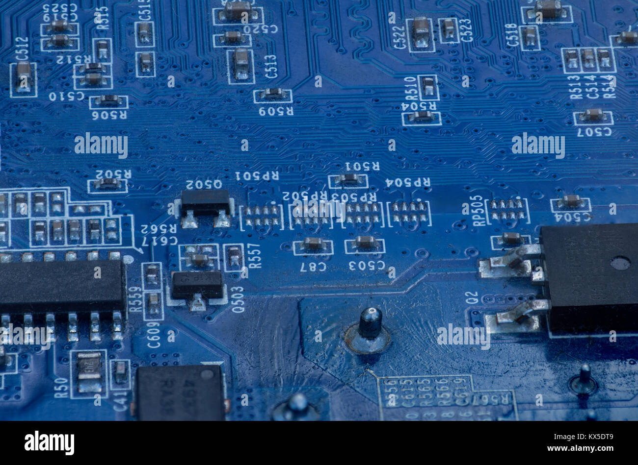 extreme close up of computer part with microcircuits in blue color ...