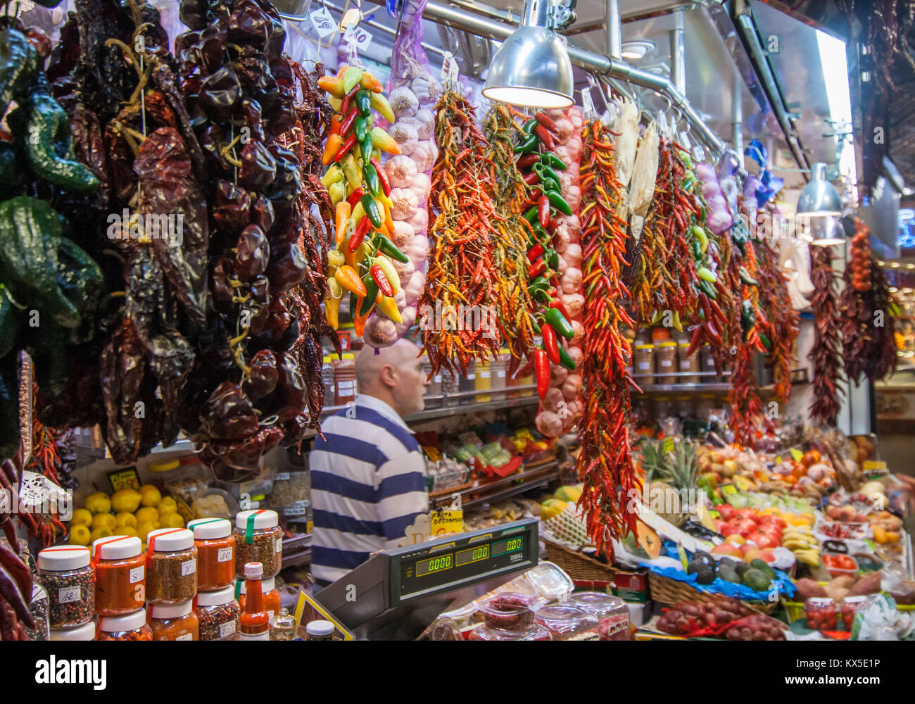 Spanish spice stand with hanging peppers of different shapes and colors ...