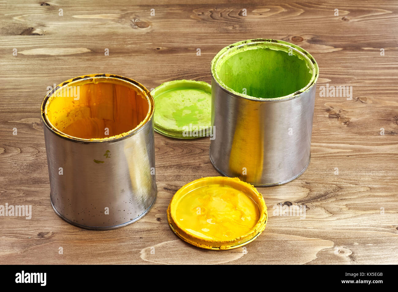 green and yellow paint cans on a rustic wooden background Stock Photo ...