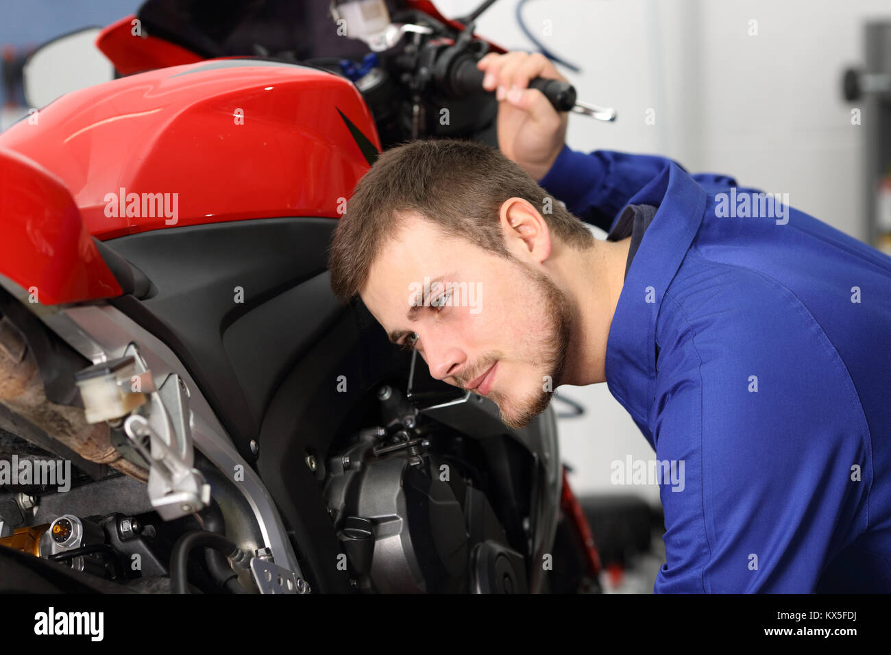 Motorcycle mechanic listening engine noise to find failures in a ...
