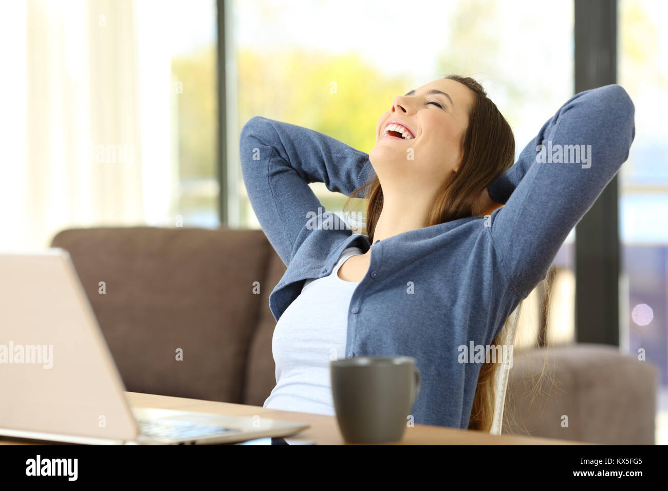 Satisfied tenant relaxing sitting on a chair at home Stock Photo - Alamy