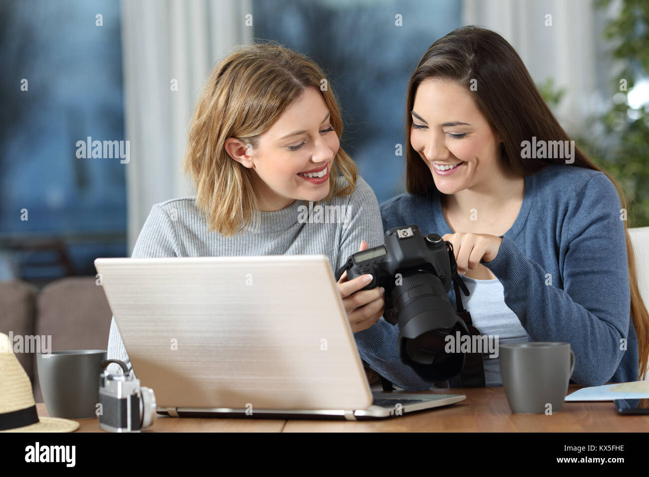 Two tourists watching photos from a dslr camera during a travel in an ...