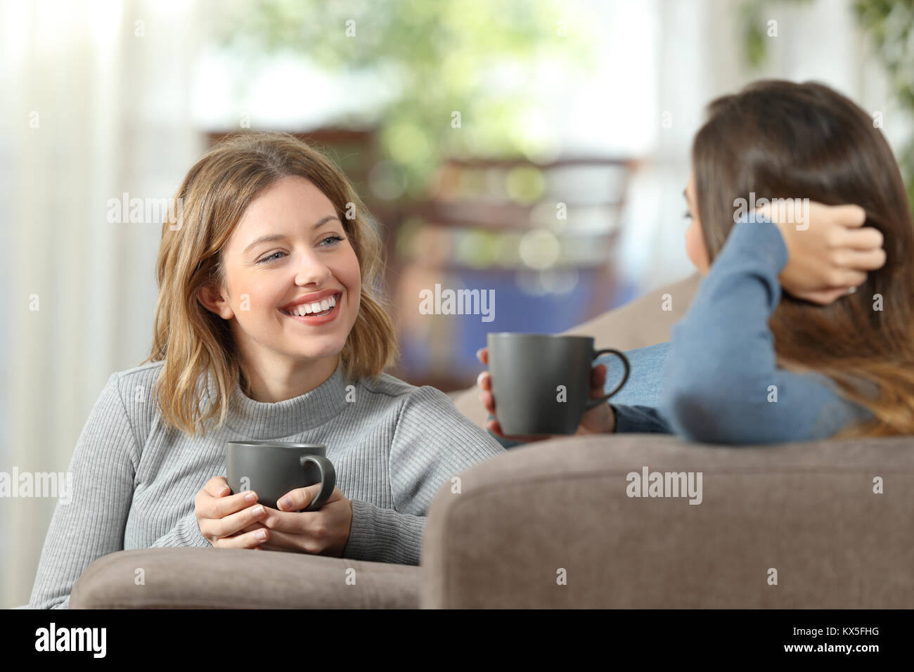 People having a conversation on sofa hi-res stock photography and ...