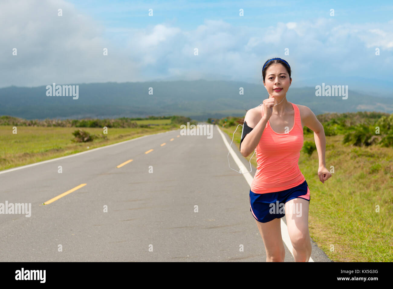 Young female runner listening hi-res stock photography and images - Alamy