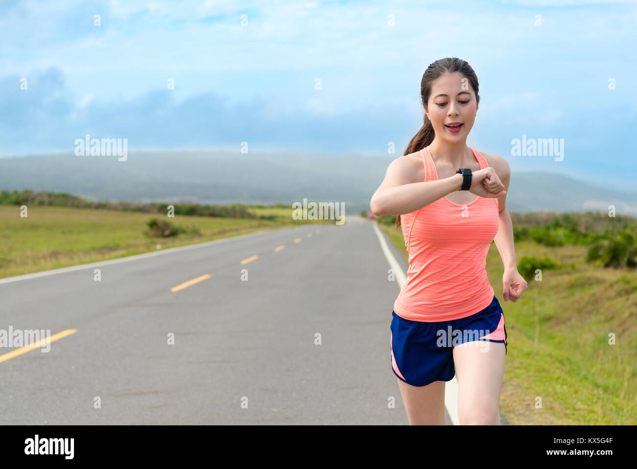 happy attractive girl runner using smartwatch system recording personal ...