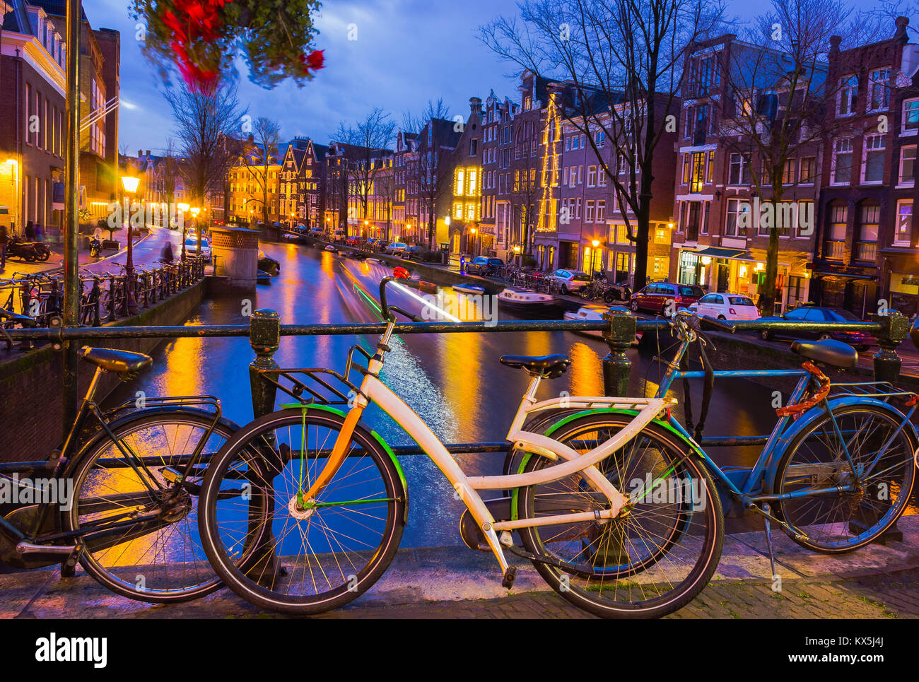 Night illumination of Amsterdam canal and bridge with typical dutch ...
