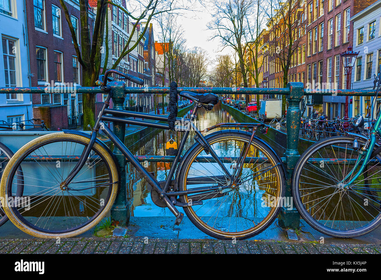 The most famous canals and embankments of Amsterdam city during sunset ...