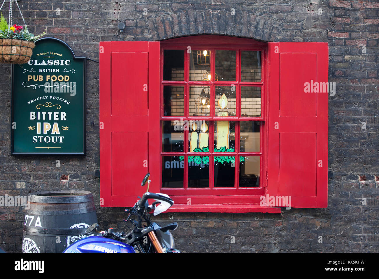 LONDON, ENGLAND - December 18 , 2017 Red shutters and a pub window ...