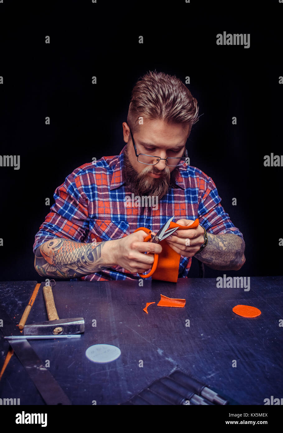 Leather Craftsman works with leather goods at his workshop Stock Photo ...