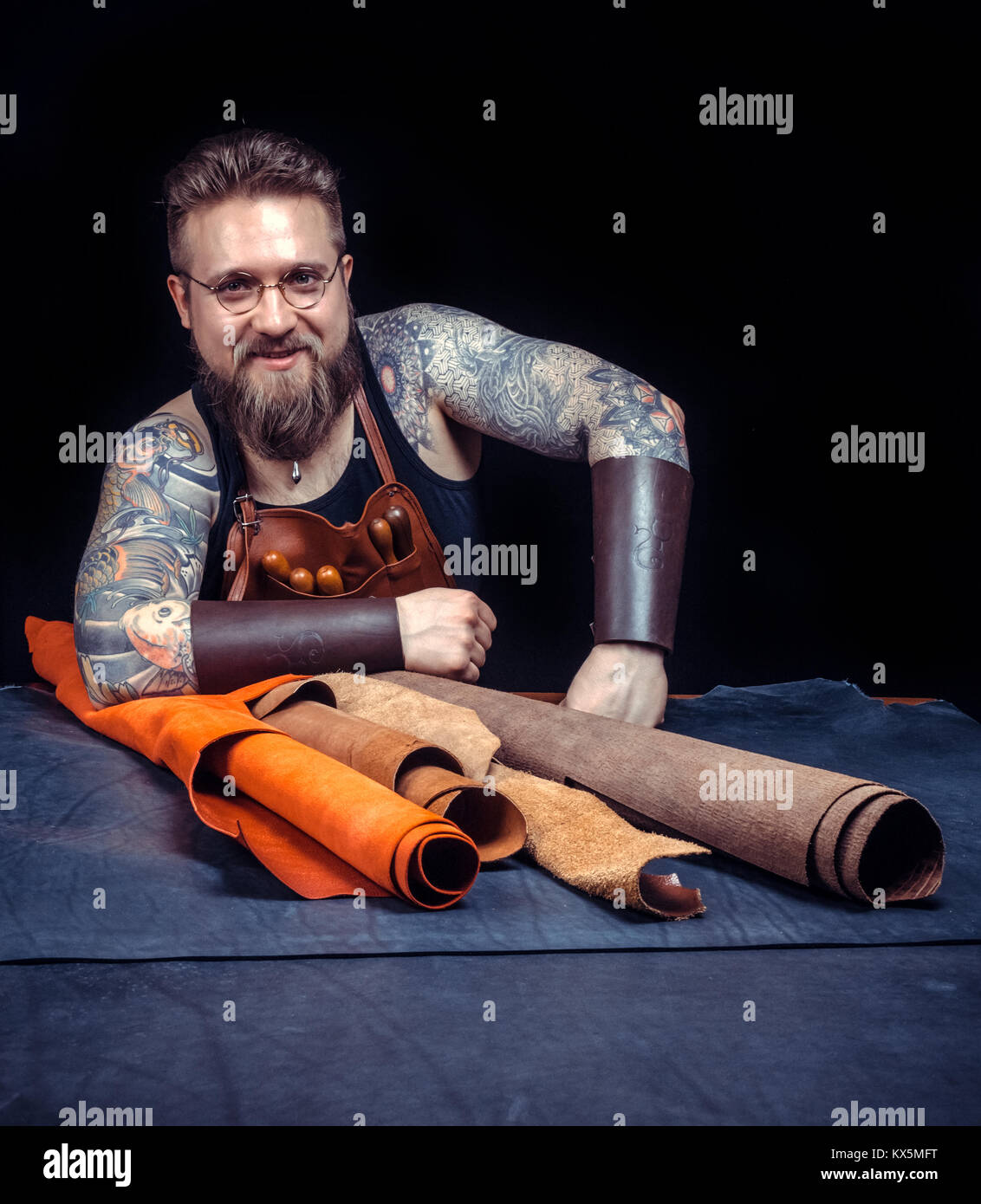 Leather Artisan producing leather workpiece Stock Photo - Alamy