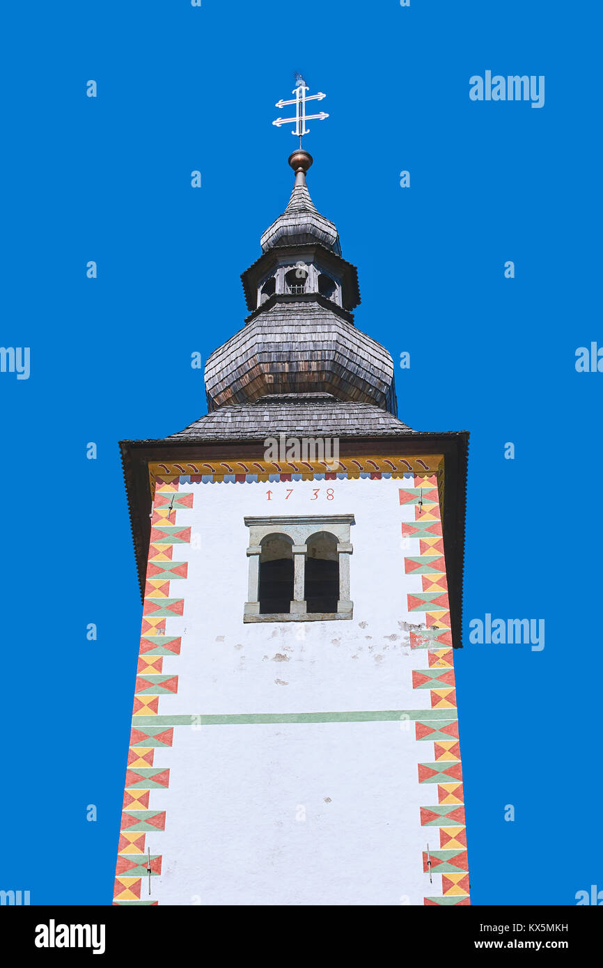 Bell tower of beautiful Slovenian church on blue sky background Stock ...