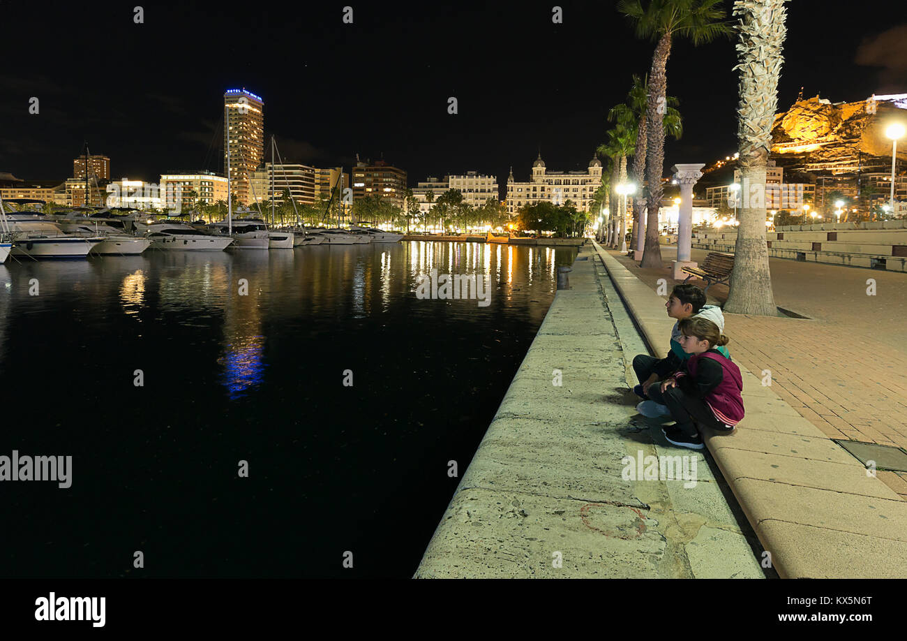 Alicante, Spain. December 28, 2017: Two children sitting on the floor ...