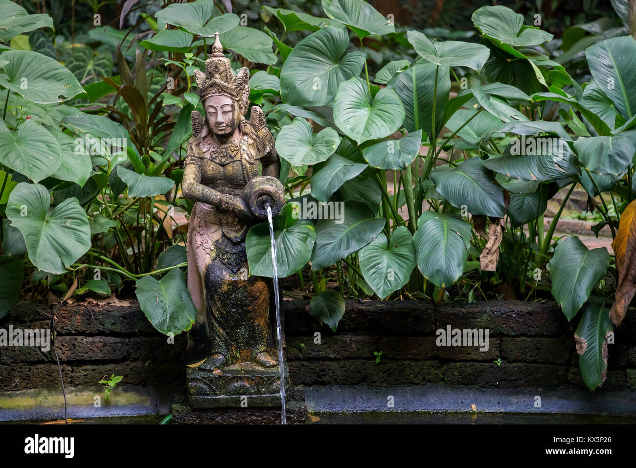 Typical Thai Garden with a fountain and a Small Pond Stock Photo - Alamy