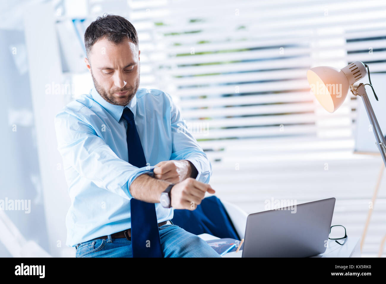 Sad young man getting ready for leaving his office and getting fired ...