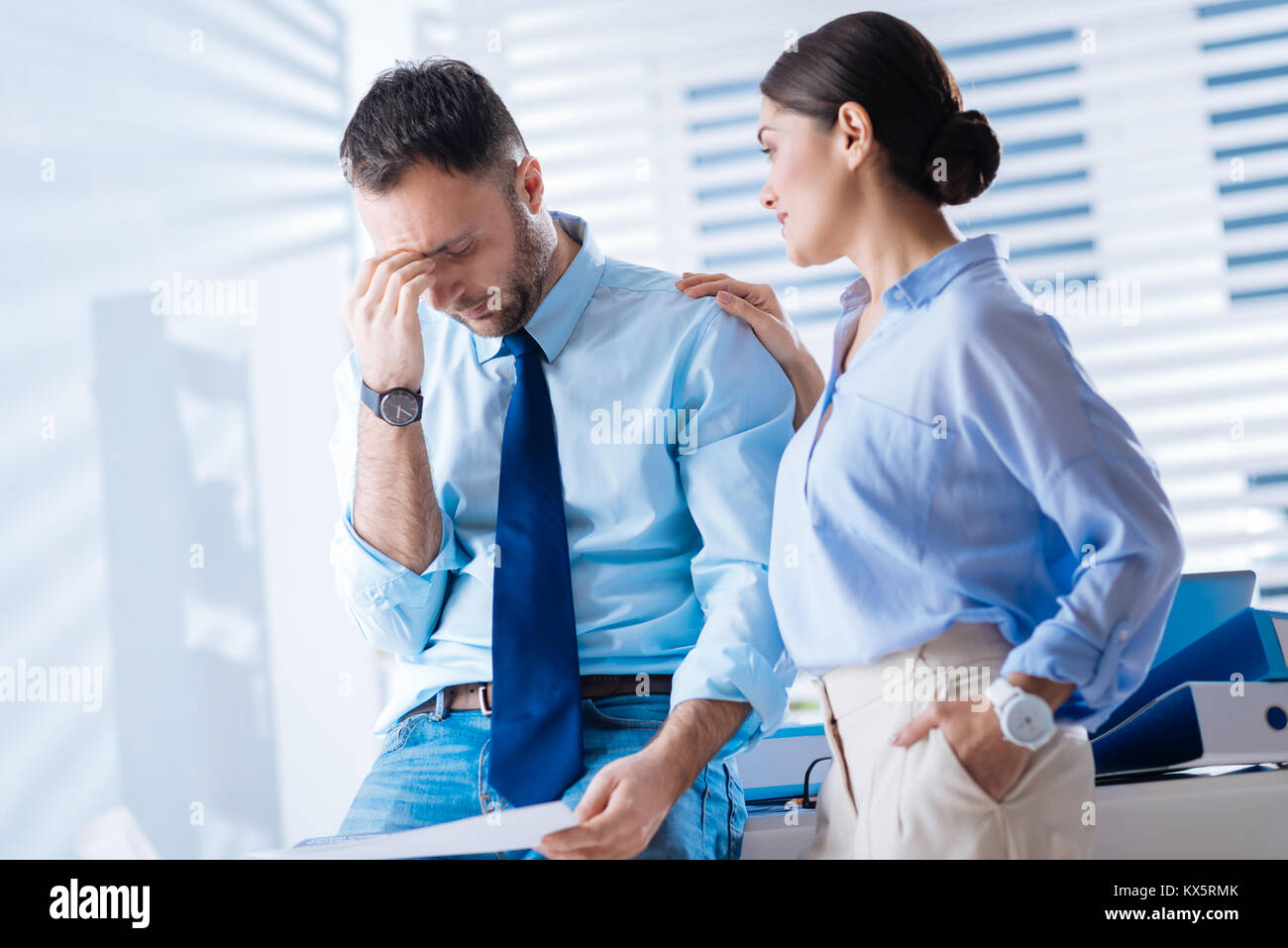 Tired employee being fed up with work while his colleague comforting ...