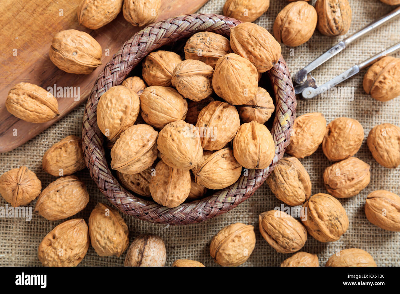 Walnuts in a small basket on a table Stock Photo - Alamy