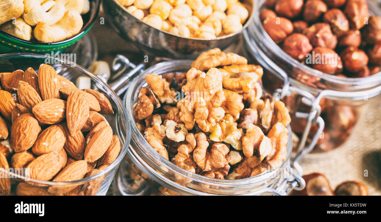Various nuts in bowls on a table Stock Photo - Alamy