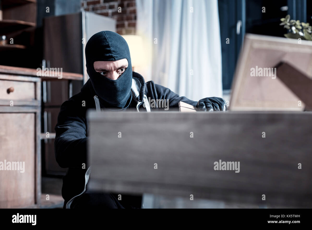 Masked thief stealing important papers Stock Photo - Alamy